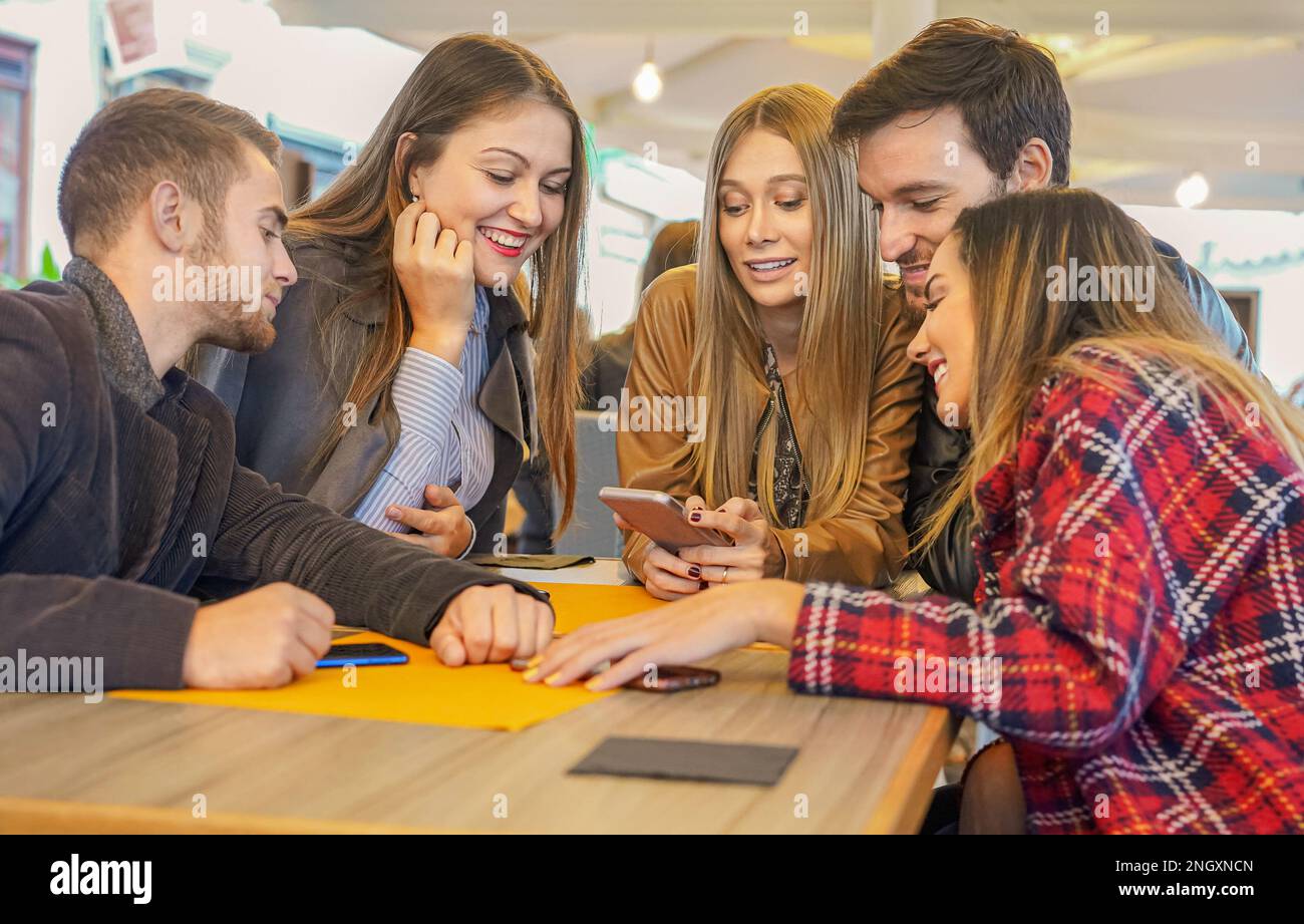 Group of people checking mobile phone hi-res stock photography and ...