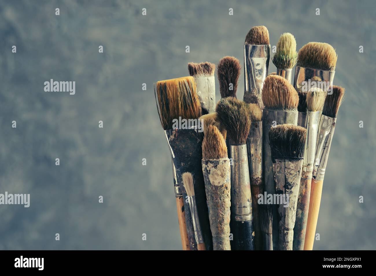 Used paint brushes on gray background. A bunch of brushes for painting ...