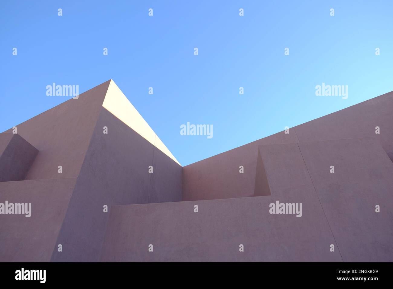 Building's rooftop structure against the clear blue sky background ...