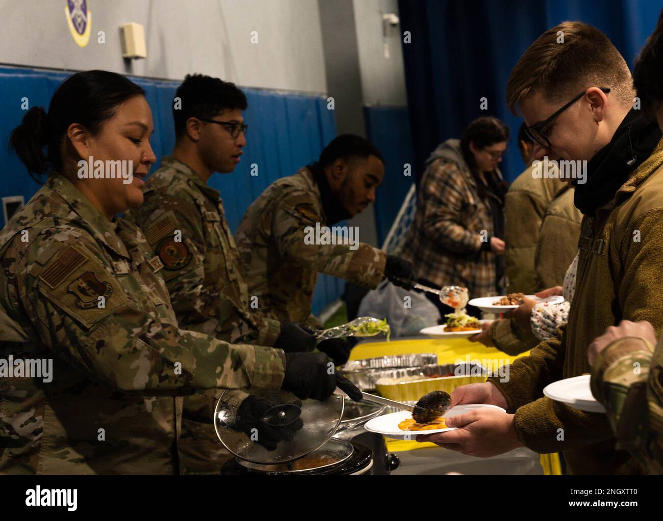 Members of Team Minot make their way through a serving line during a ...