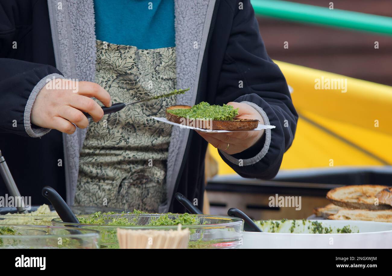 Making herb toasts at farmers street food market in Prague, Czech ...