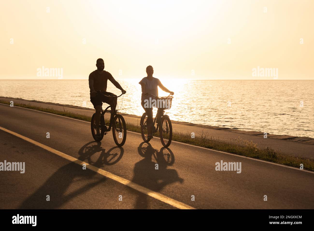 Caucasian couple taking pleasure in the ride on beach cruiser bikes ...