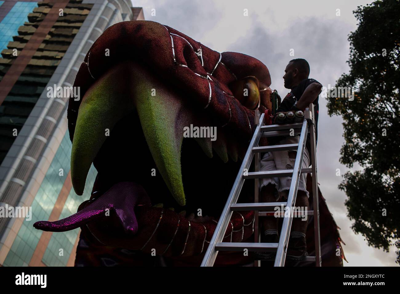 A man works on a float before the samba school parade during Carnival ...