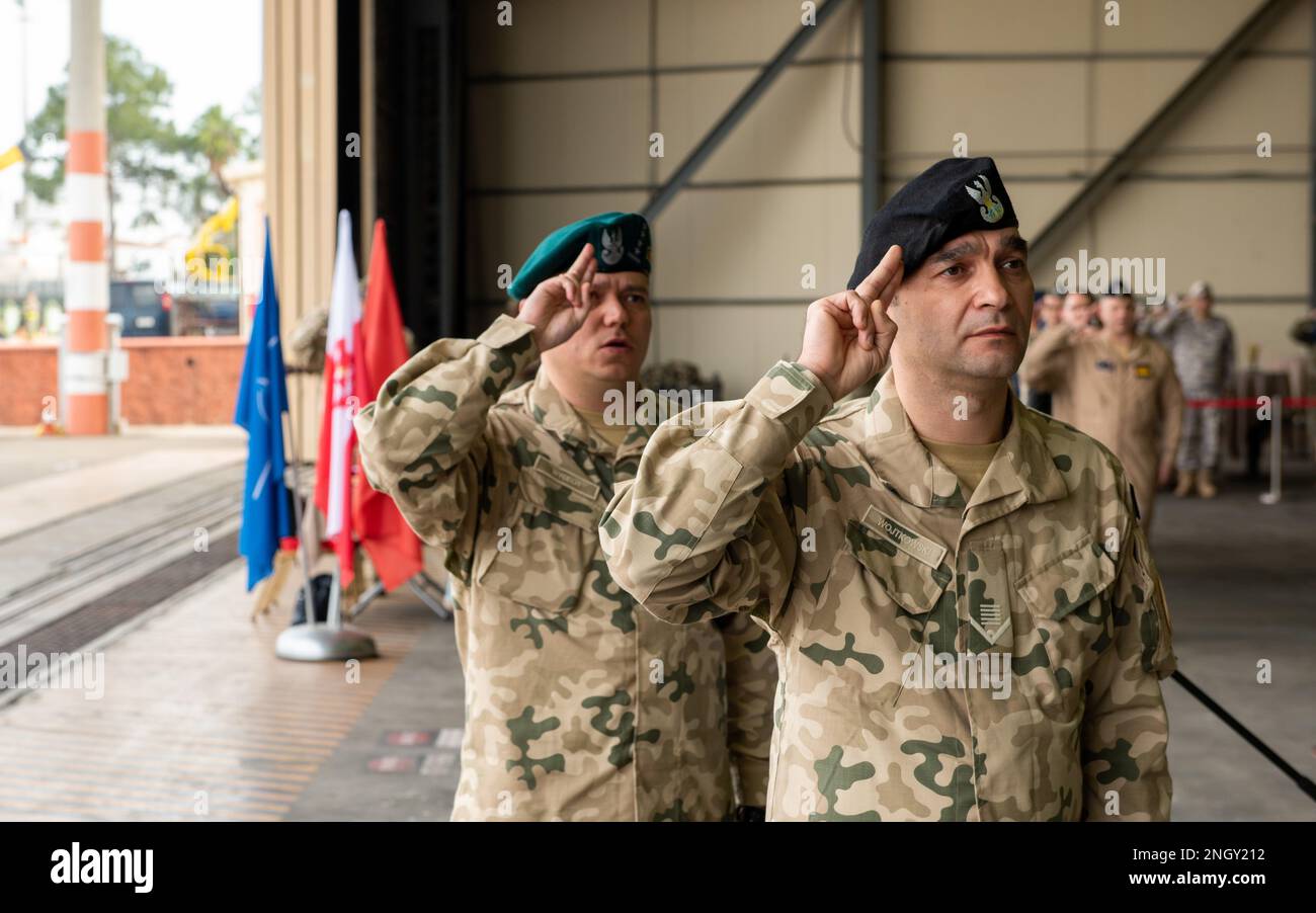 Polish Military Contingent members salute the Polish flag while it was ...