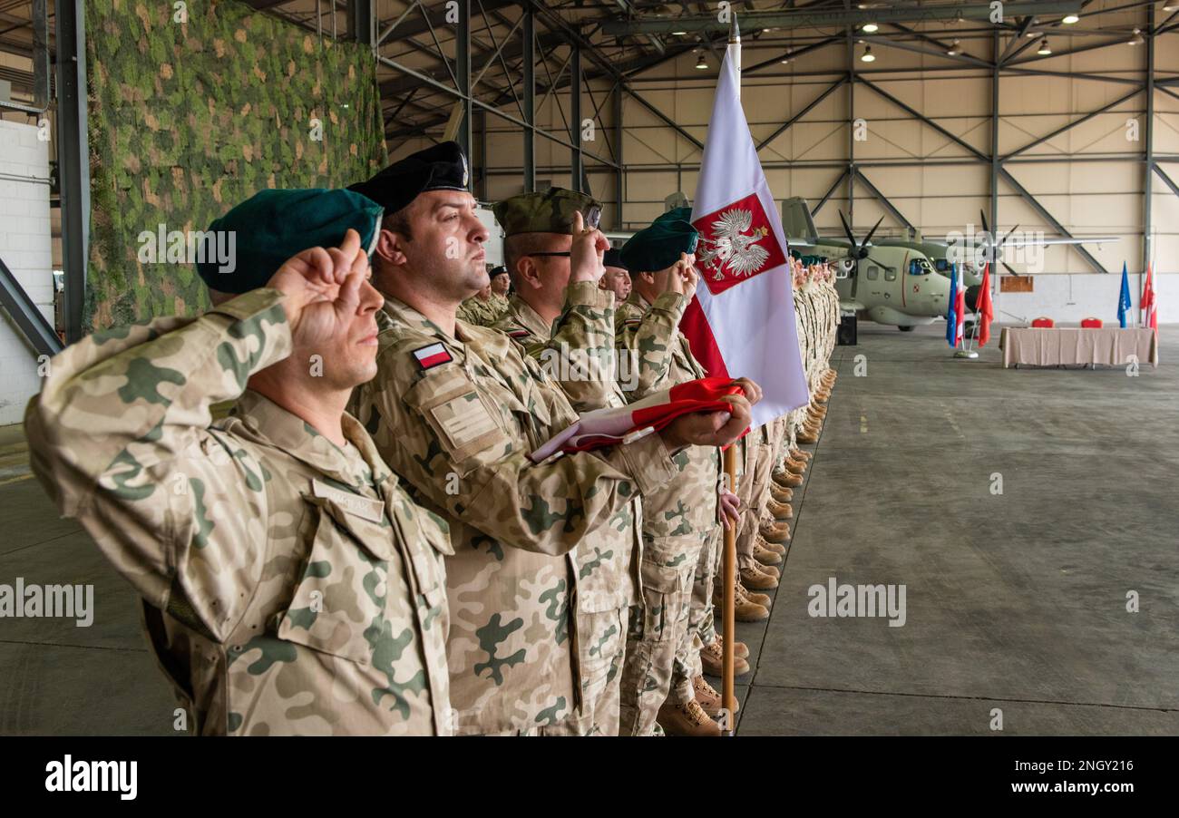 Polish Military Contingent members salute during a change of command ...