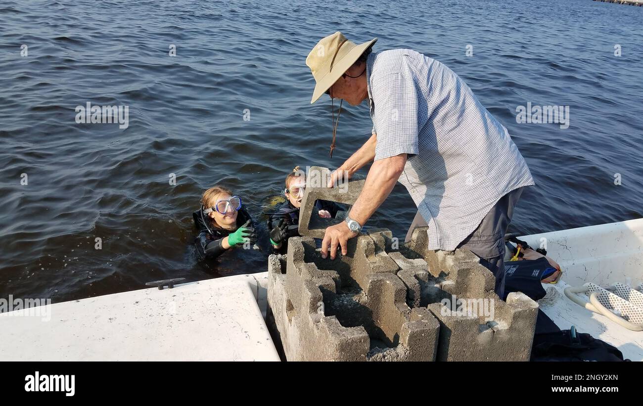 NY/NJ Baykeeper divers in the Raritan Bay being handed an oyster castle ...