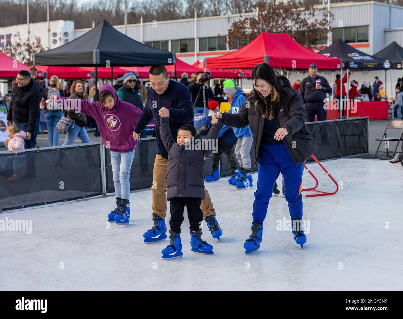 U.S. Marines and their families ice skate during the annual holiday ...