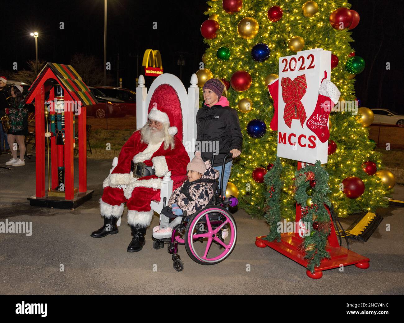 Families Pose For Pictures With Santa During The Annual Holiday Tree