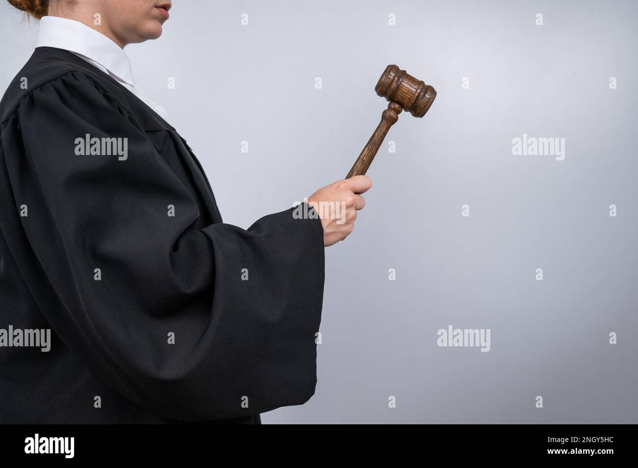 Steadfast female judge in a robe holding a court gavel Stock Photo - Alamy