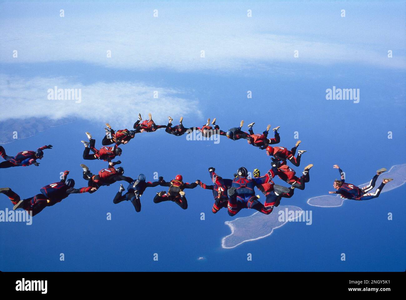 Mass skydiving stunt where multiple people hold hands and form a circle ...
