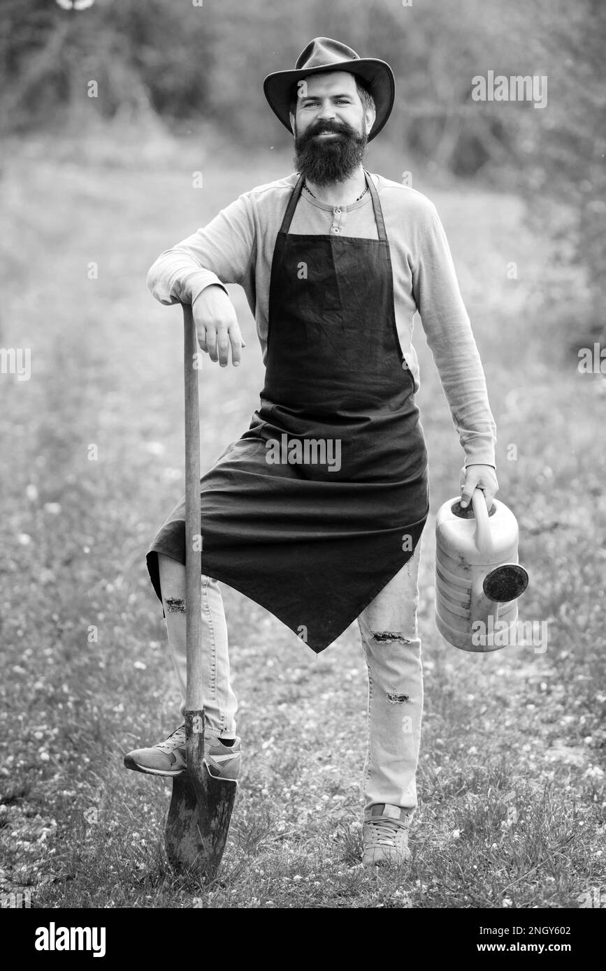 Farmar enjoy spring nature and take care about her plants. Gardener ...