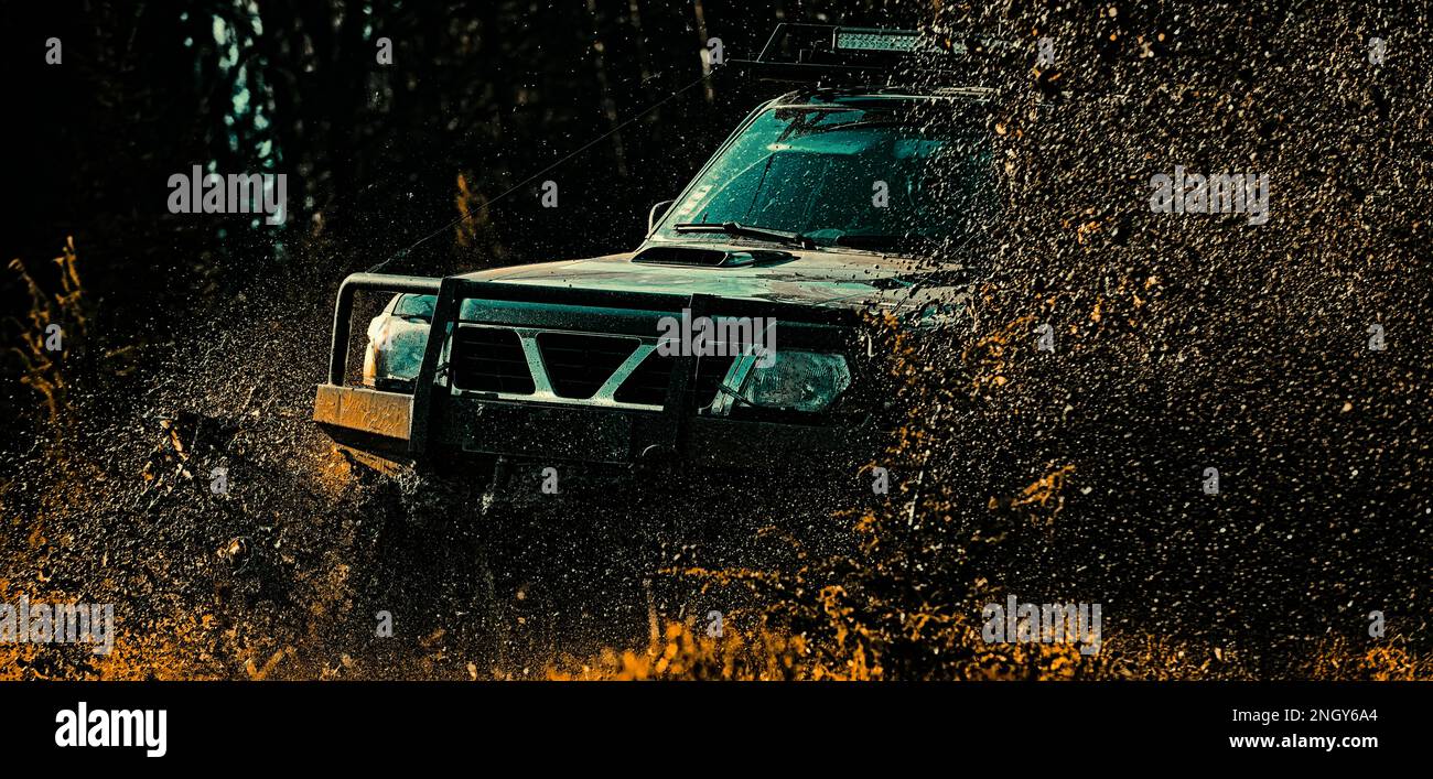 Mud and water splash in off-road racing. Drag racing car burns rubber ...