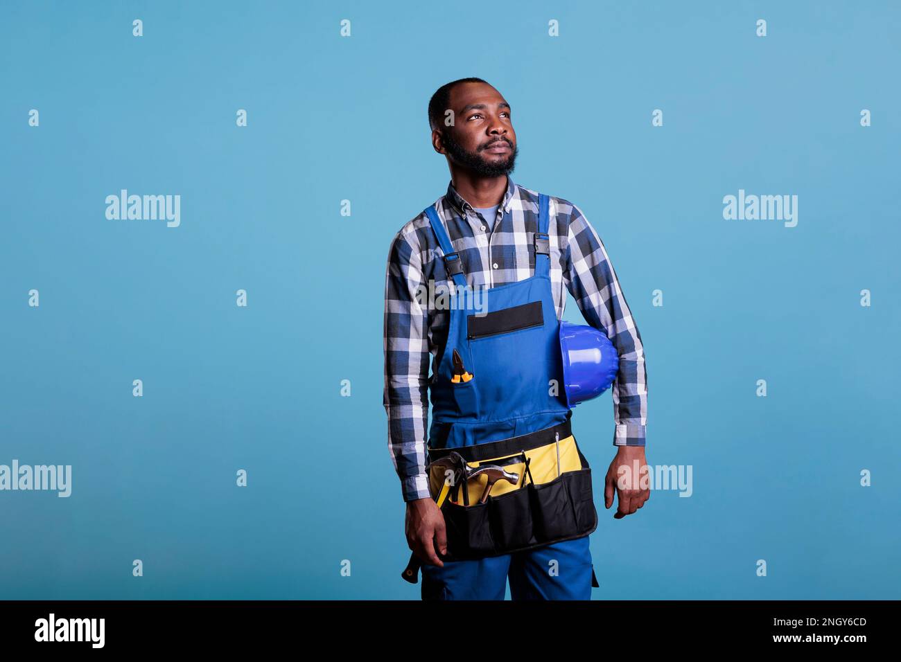 African american construction worker thoughtful looking into distance ...