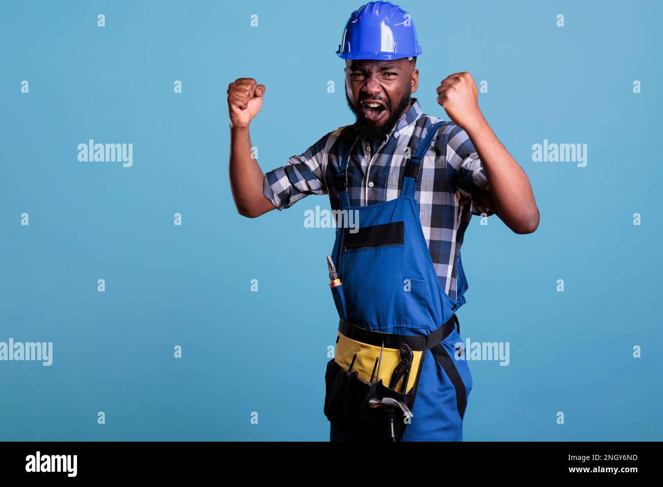 Portrait of an angry african american construction employee, shouting ...