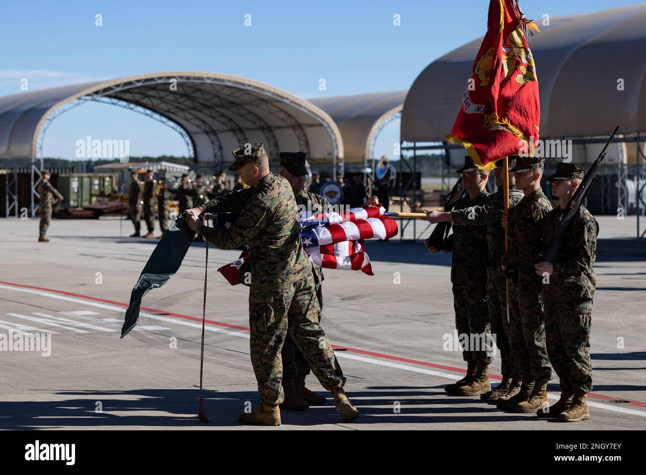 U.S. Marines with Marine Attack Squadron (VMA) 542 fold an American ...