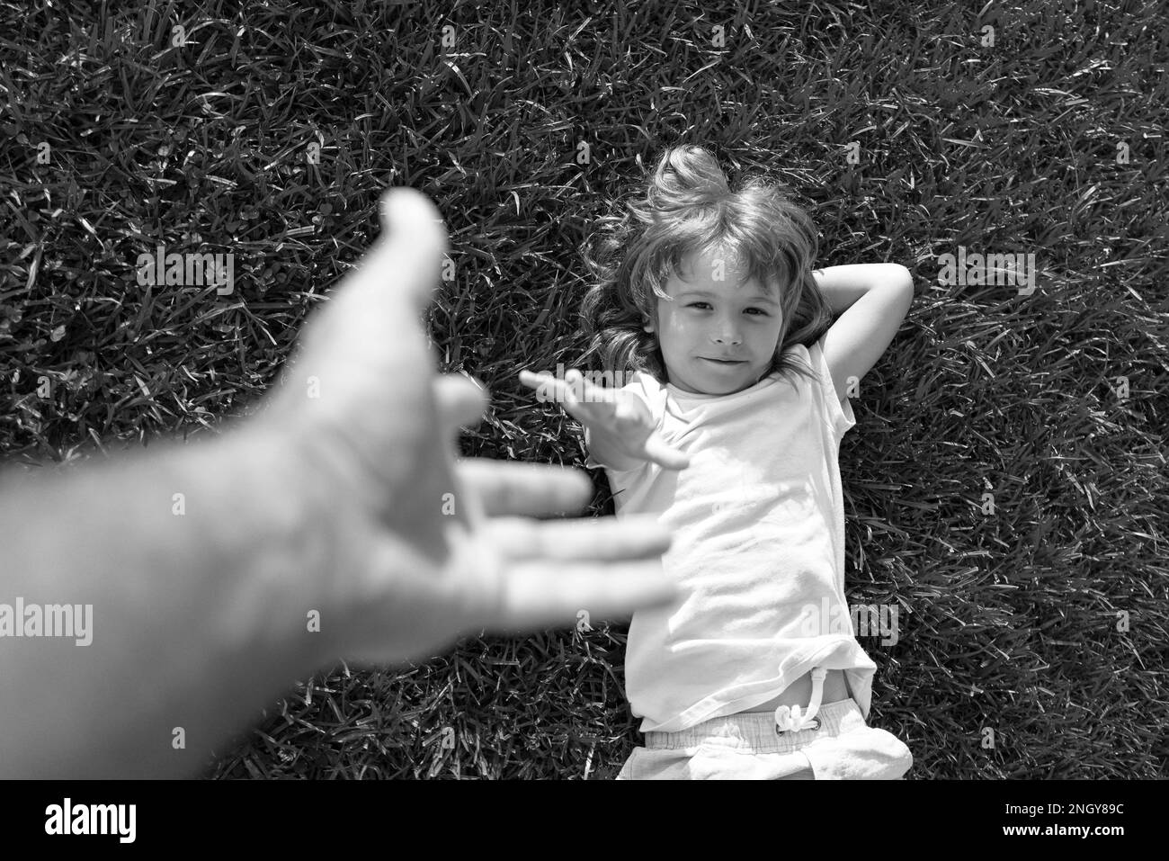 Kid pull father hand. Follow me, hand-in-hand walking on bright sunny ...