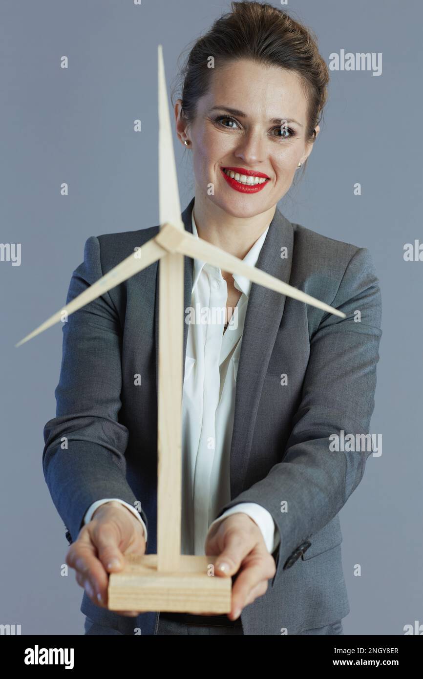 happy elegant 40 years old woman employee in gray suit with windmill ...