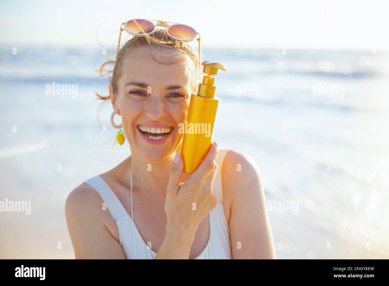 Portrait of smiling modern 40 years old woman in white swimsuit at the ...
