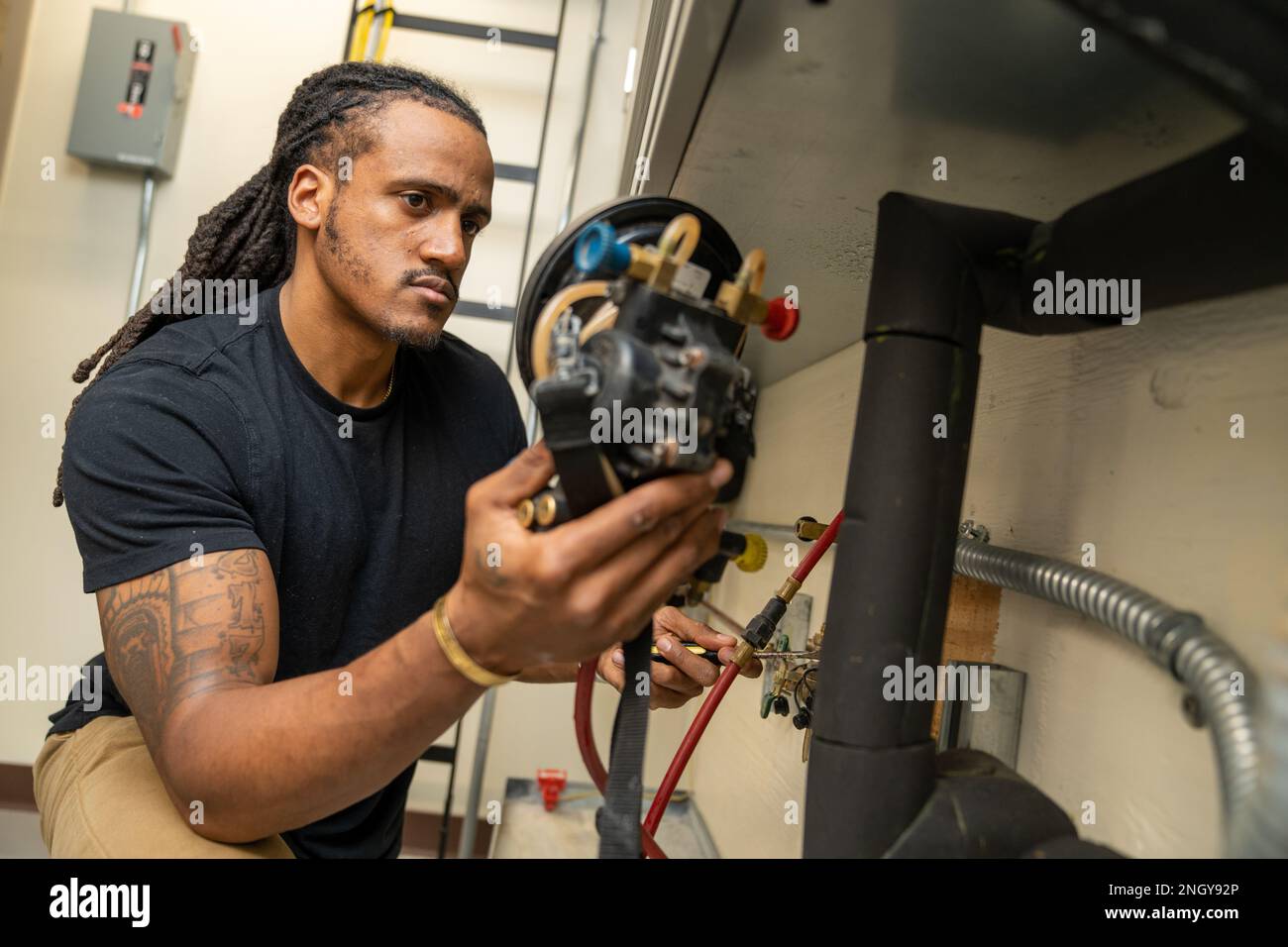 Joshua Douglas, 502nd Civil Engineer Squadron plumber, examines a ...