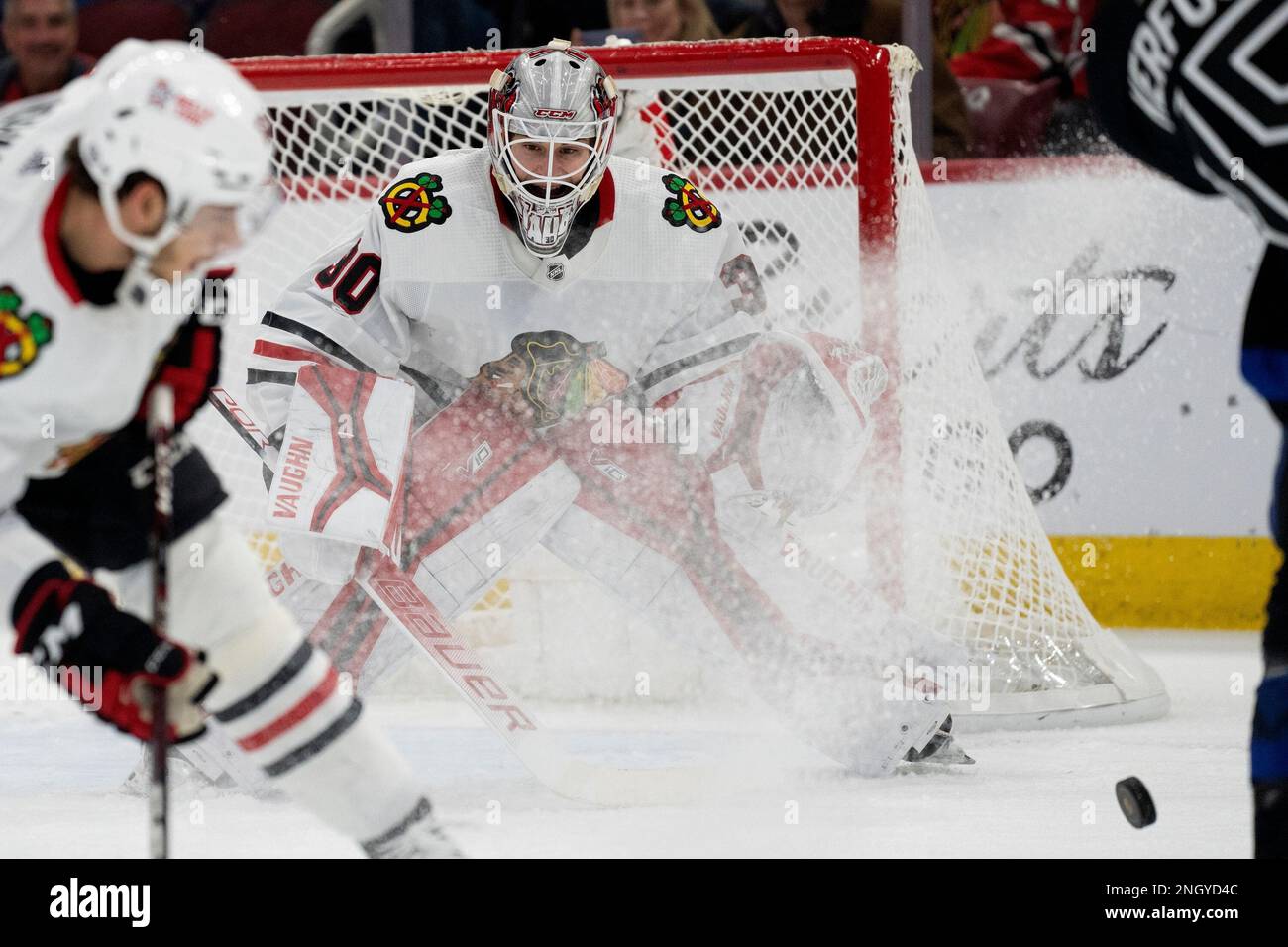 Chicago Blackhawks goaltender Jaxson Stauber (30) looks for the puck ...