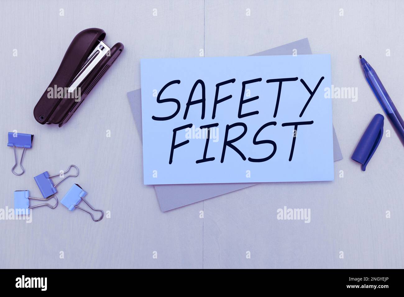 Hand writing sign Safety First. Word Written on Avoid any unnecessary ...