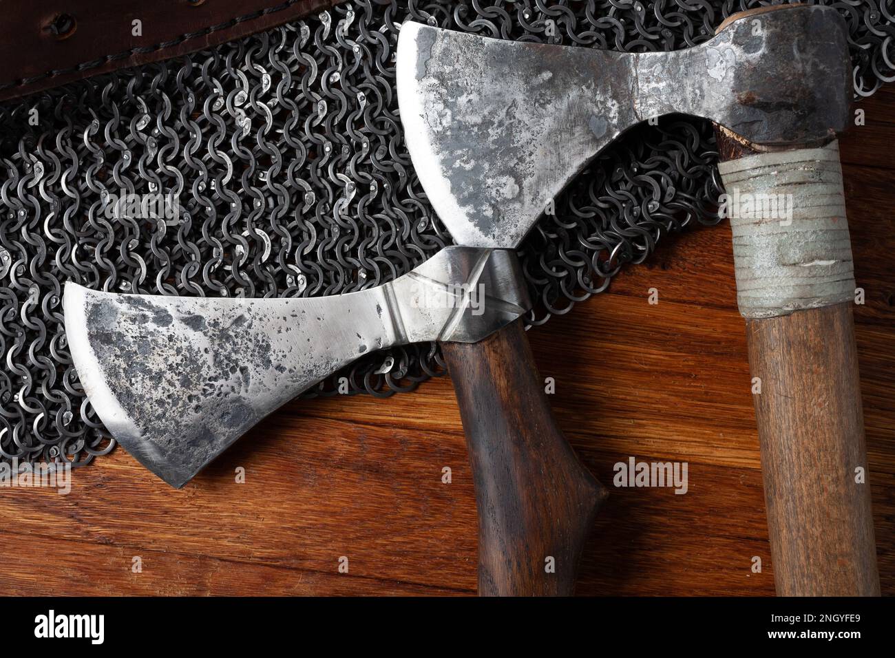 battle axes on chain mail armor background Stock Photo - Alamy