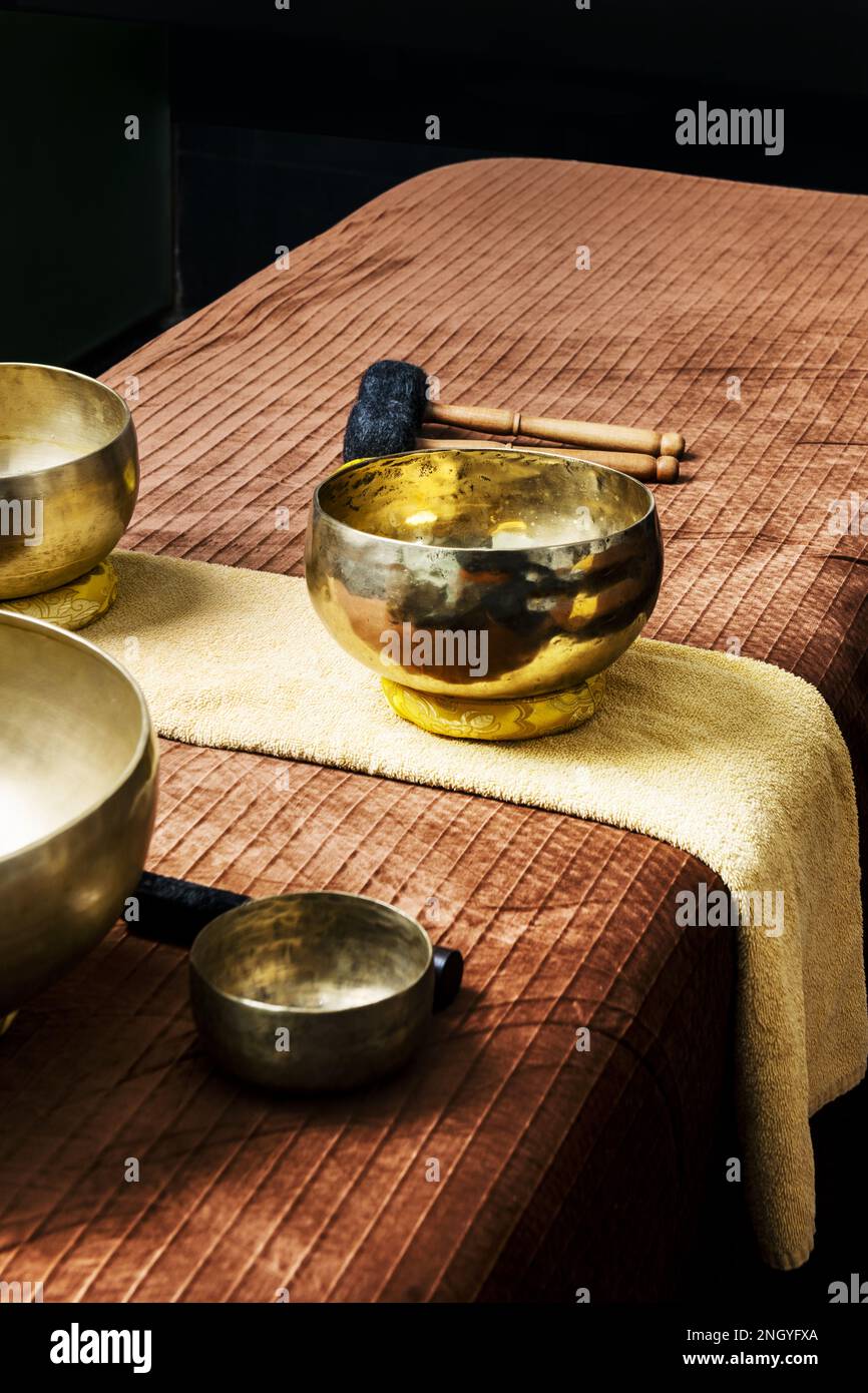 Tibetan metal bowls for the ritual of relaxing massages on a table with ...