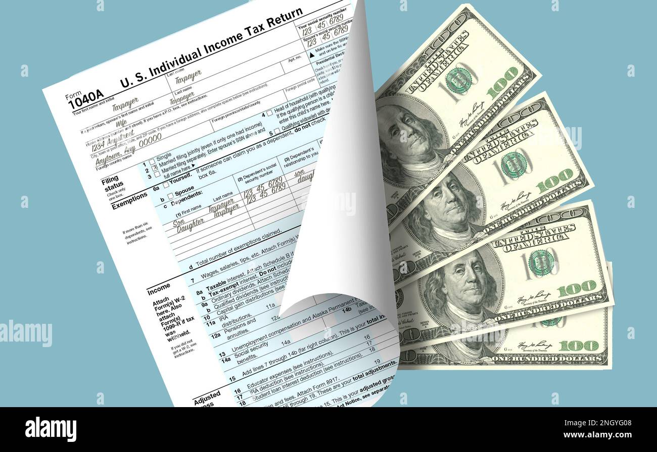 A USA federal income tax form 1040 is seen with four one-hundered ...