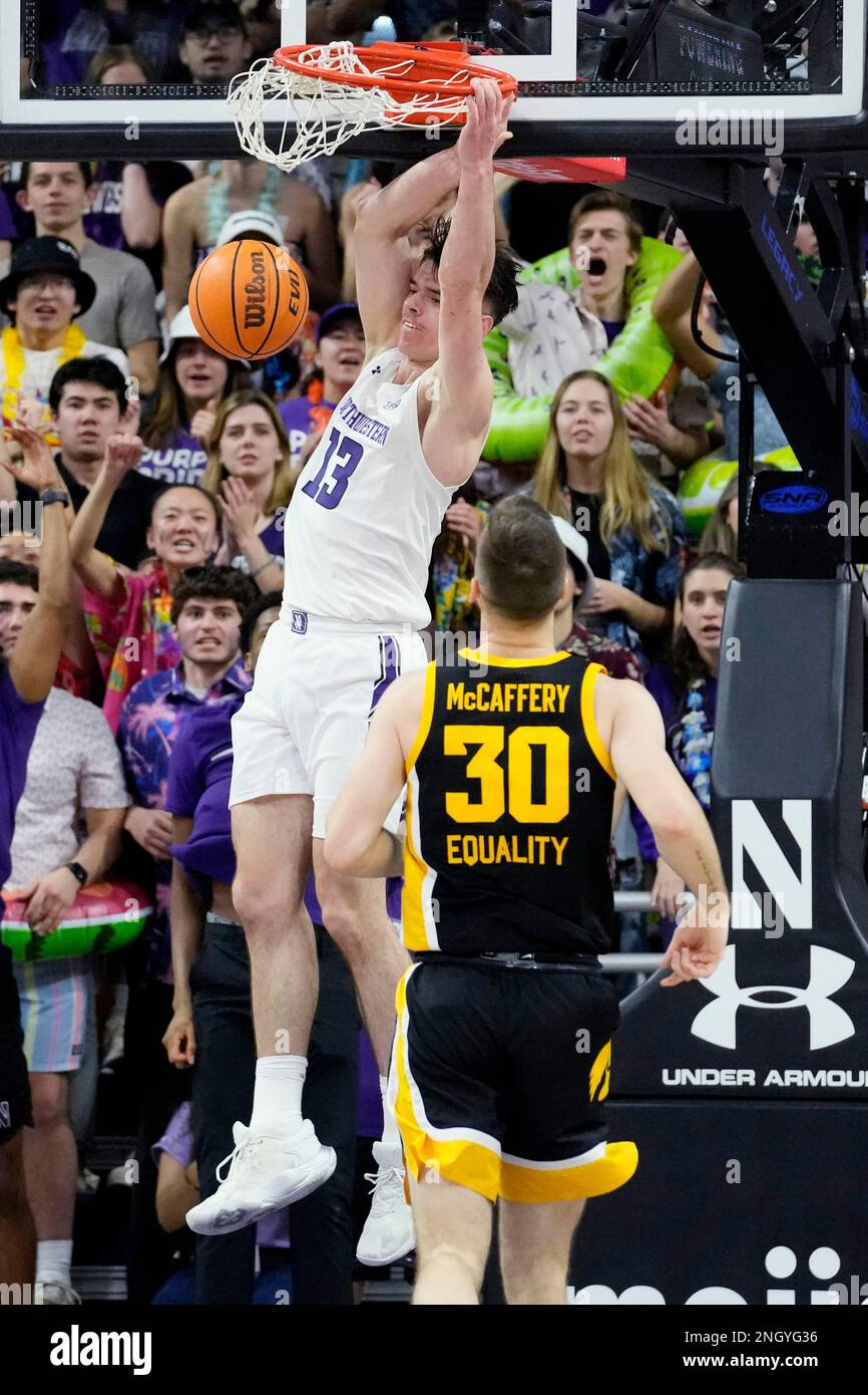 Northwestern guard Brooks Barnhizer (13) dunks as Iowa guard Connor ...
