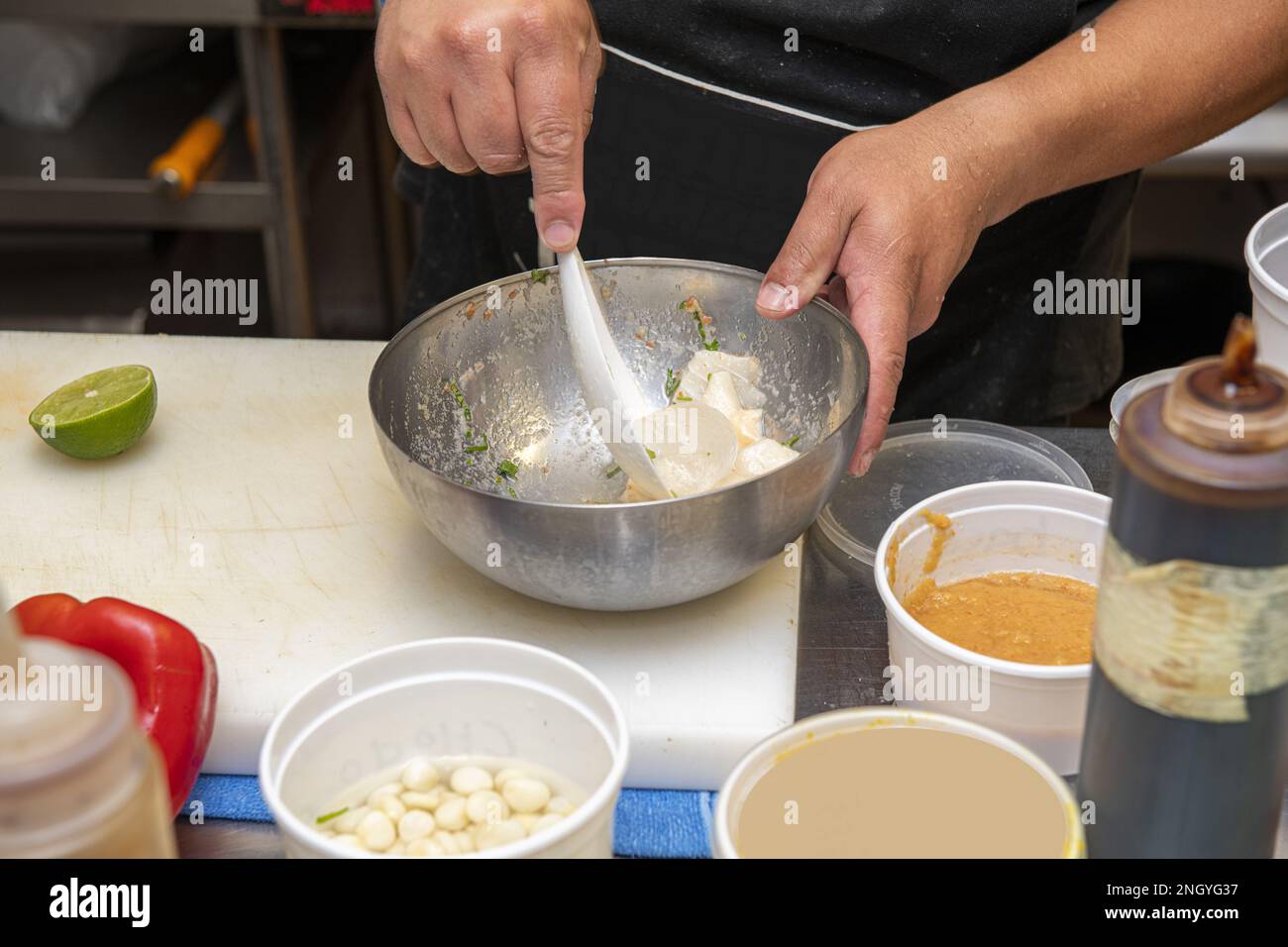 A Peruvian cook preparing ceviche with a citrus fish marinade in a ...