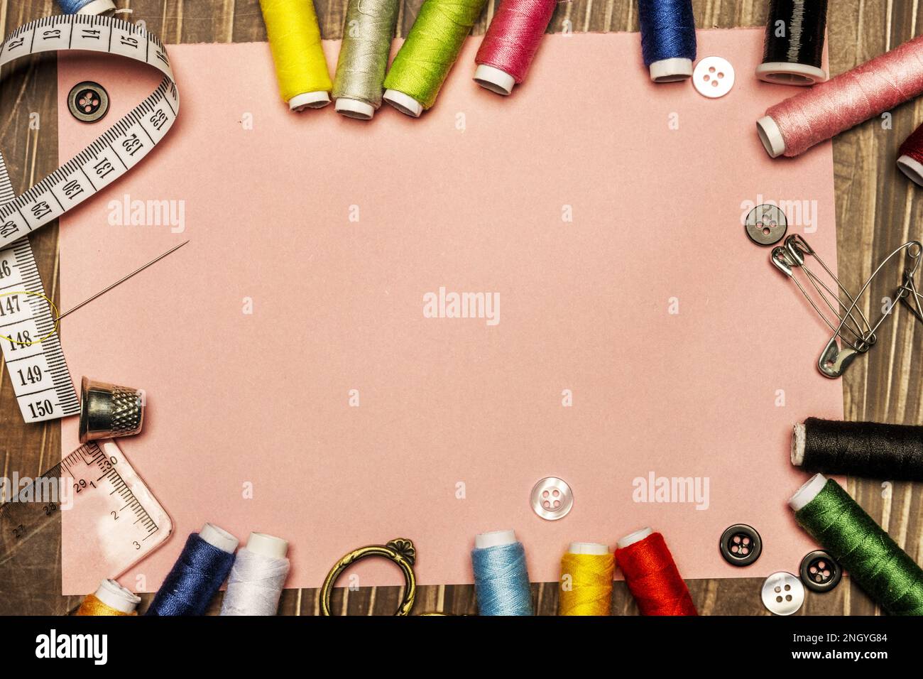 A composition of sewing material with many spools of colored thread ...