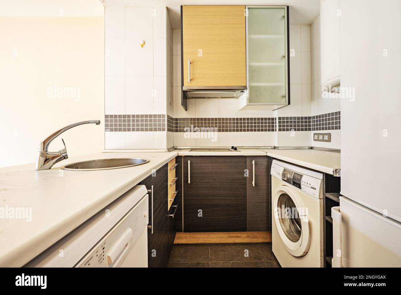 kitchen with serving hatch, two-tone wooden furniture, white walls ...