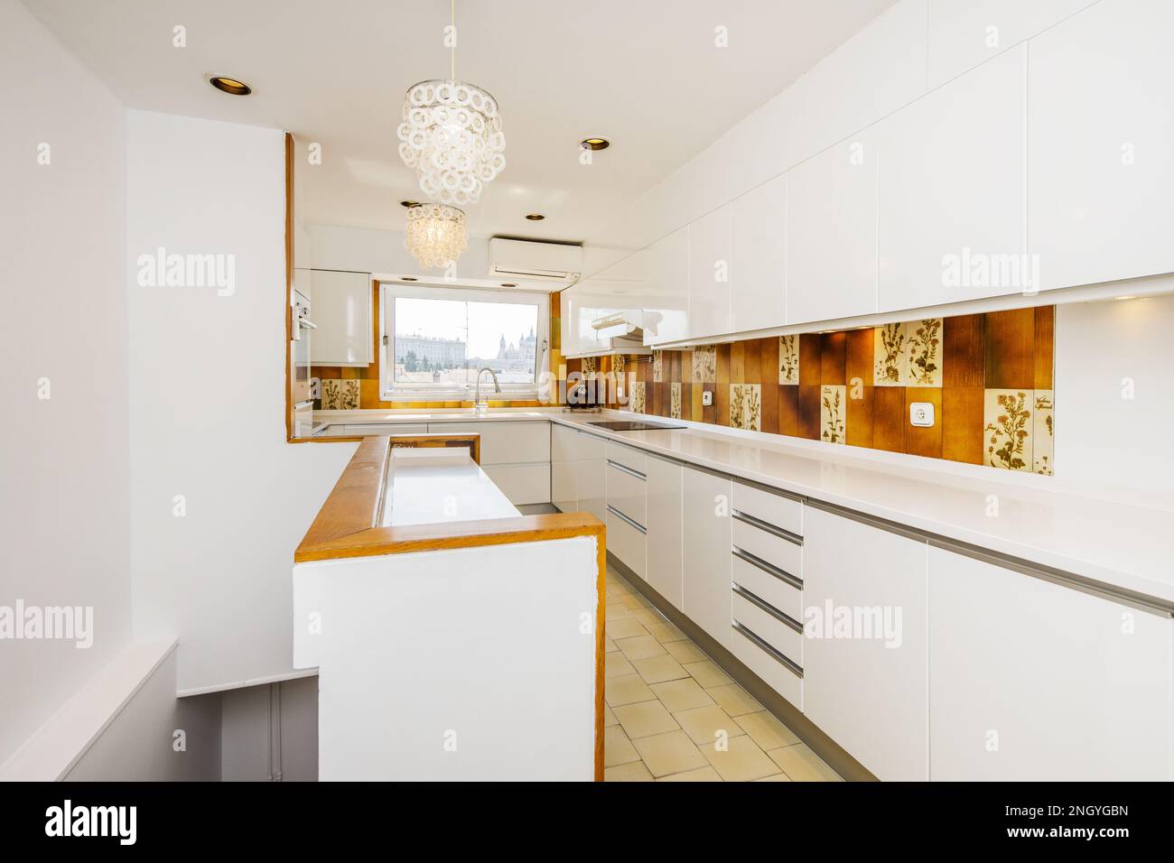 elongated kitchen with plain white cabinets, white faux stone ...