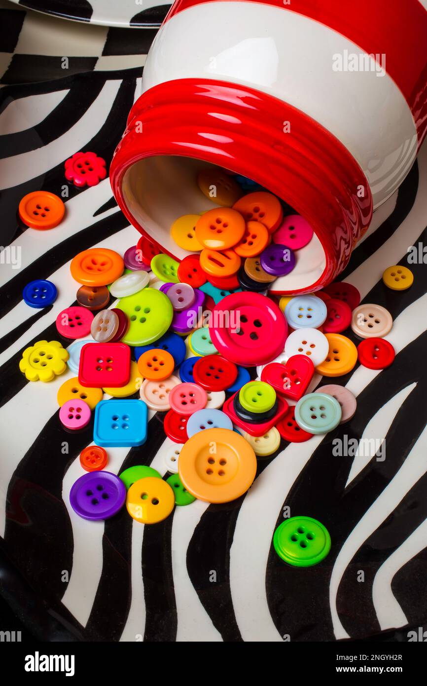 Red White Jar Spilling Buttons Stock Photo - Alamy