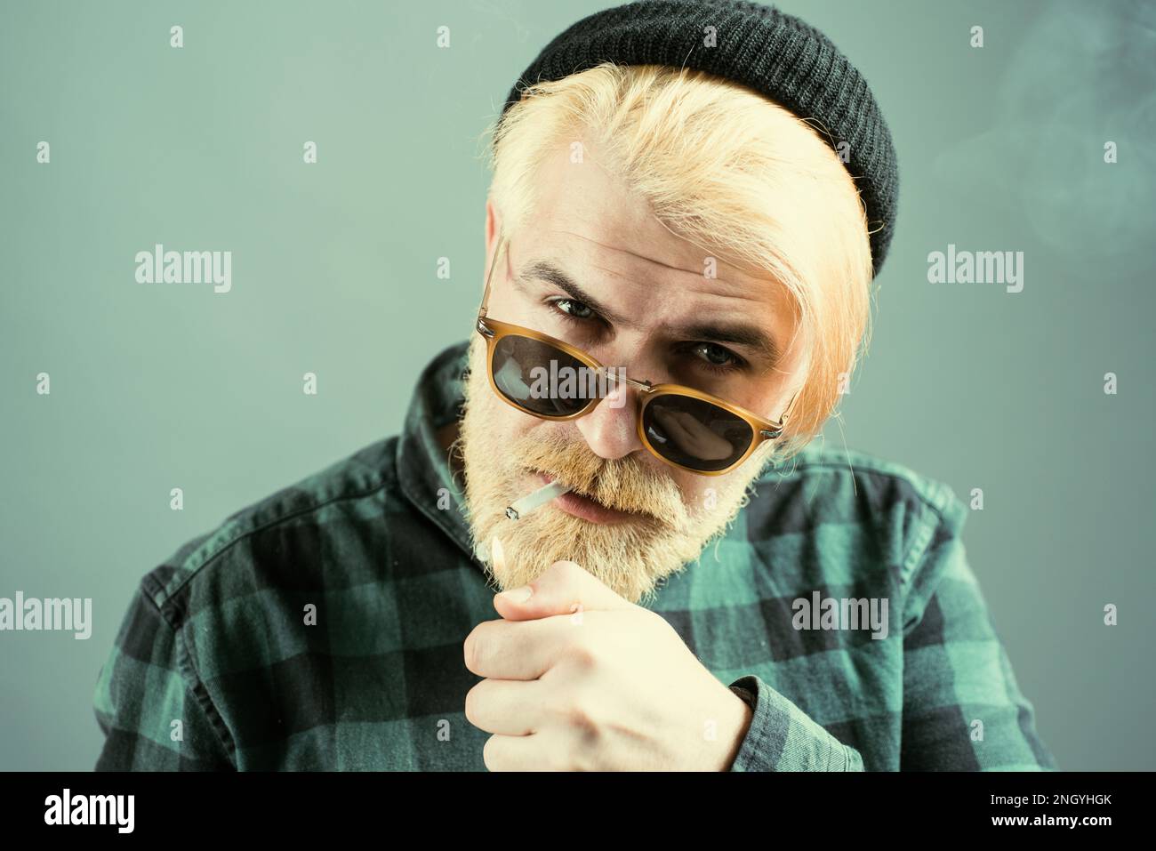 Man smoking. Close up face of a young man without emotions. Portrait ...