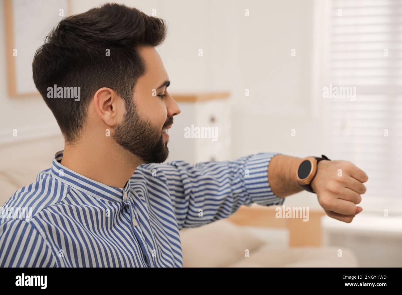 Young man using smartwatch in hi-res stock photography and images - Alamy