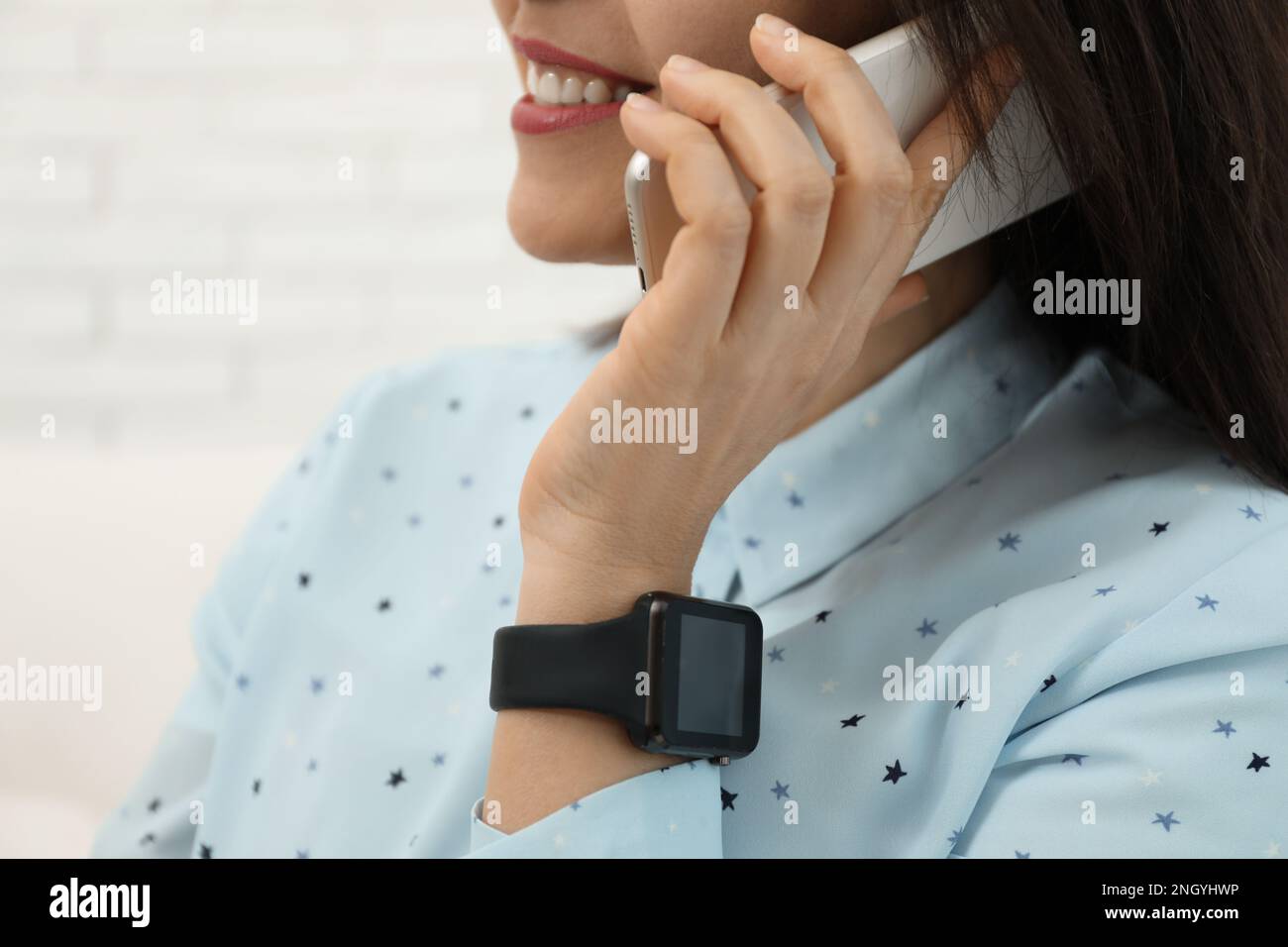 Mature woman with smart watch talking on phone indoors, closeup Stock ...
