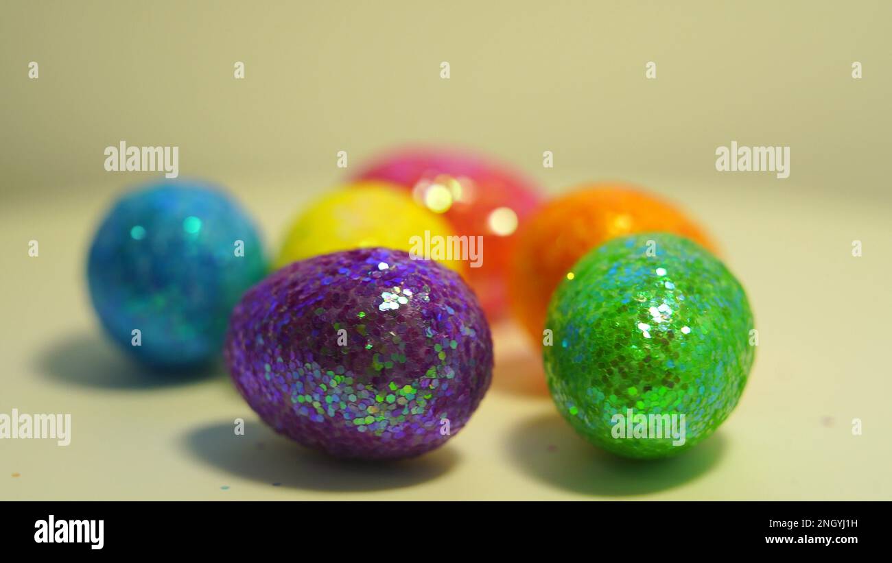 Colorful Easter eggs rotating in rows in a seamless loop on a light ...