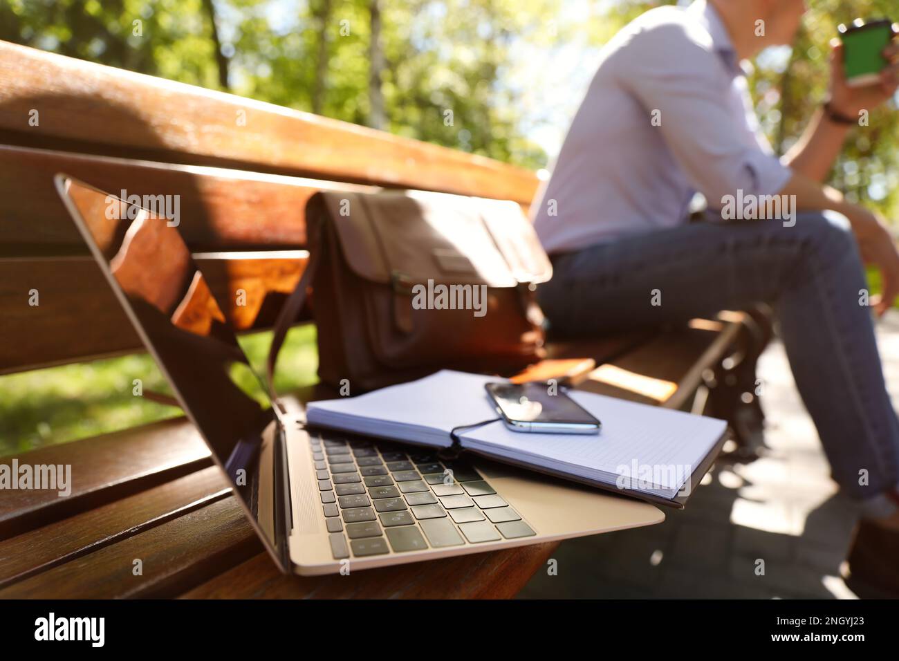 Man taking coffee break during work in park, focus on laptop Stock ... Man taking coffee break during work in park, focus on laptop Stock ...