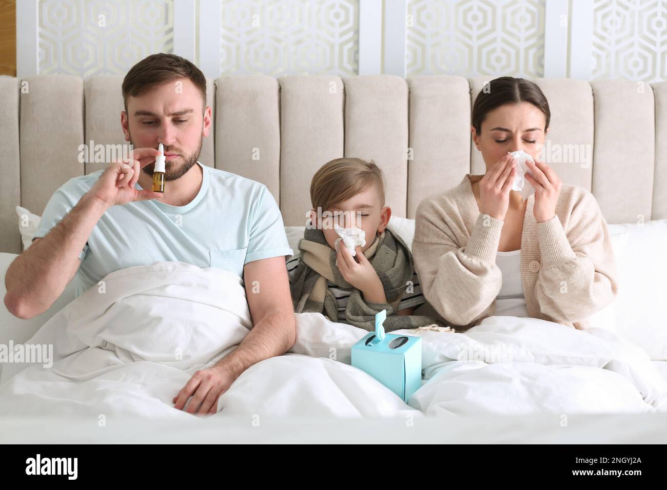 Family suffering from runny nose in bed at home Stock Photo - Alamy