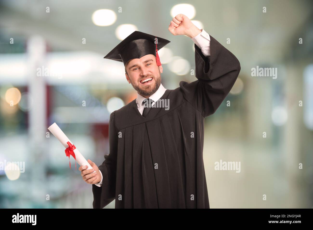 Happy student with graduation hat and diploma indoors Stock Photo - Alamy