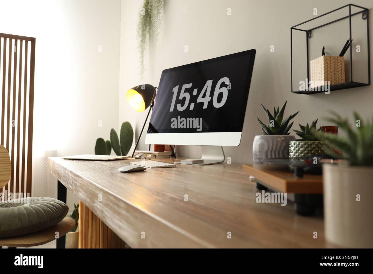 Modern computer and laptop on wooden desk in room. Interior design ...