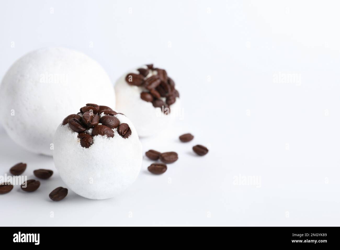 Bath bombs and coffee beans on white background, space for text Stock ...