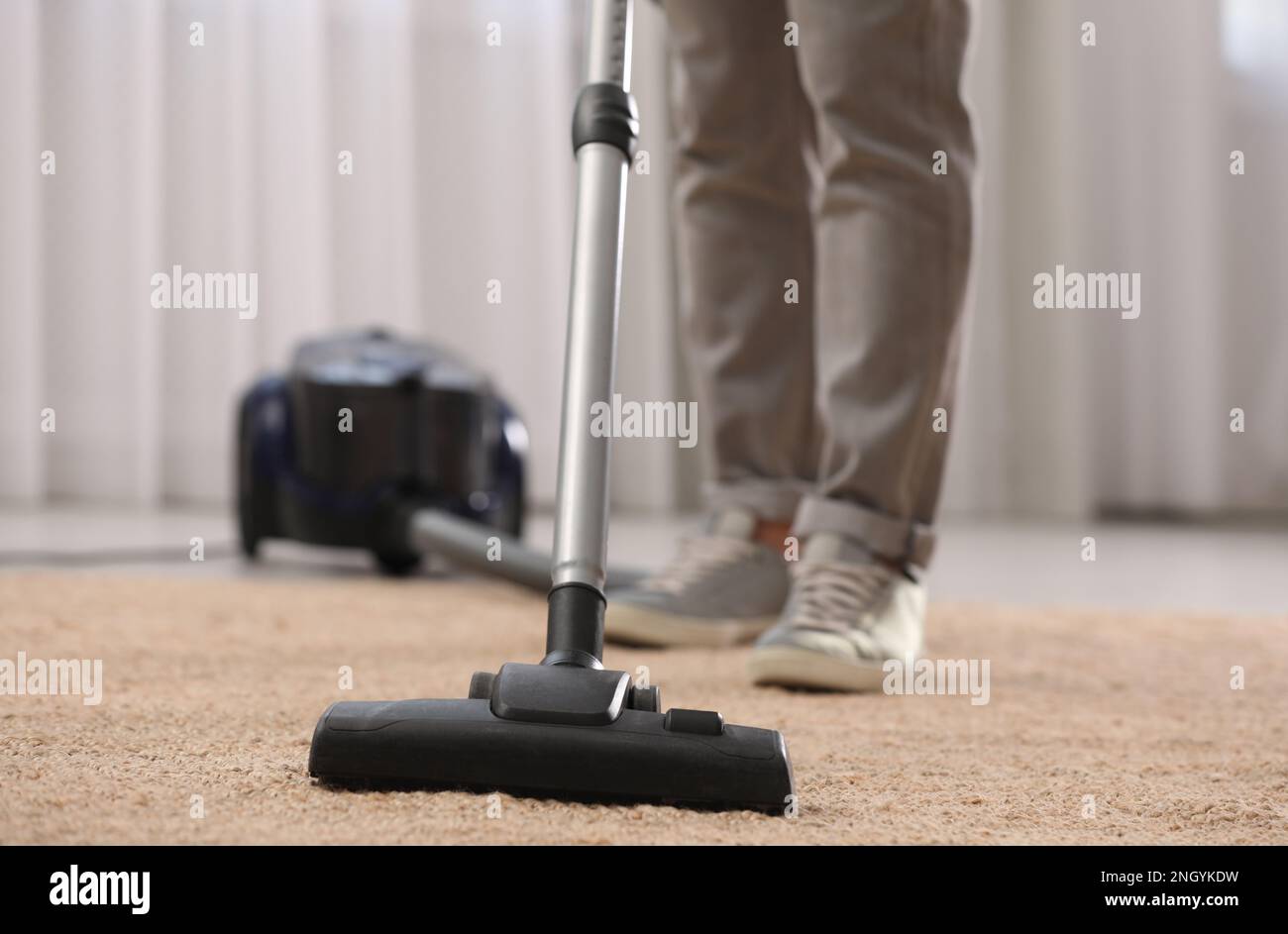 Man vacuuming beige carpet hi-res stock photography and images - Alamy