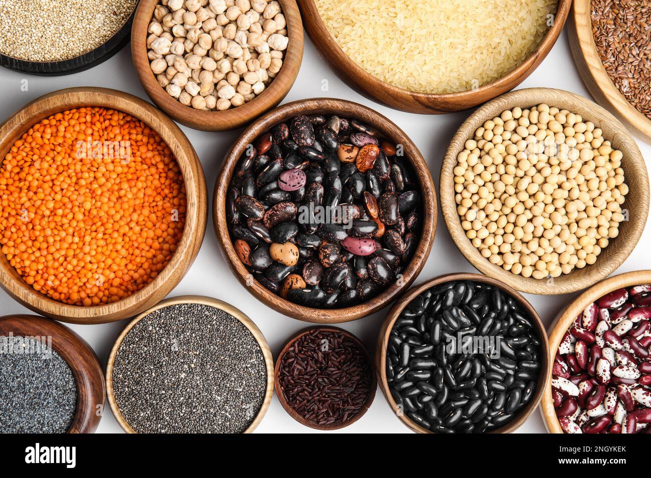 Various raw veggie seeds in bowls on white background, top view Stock ...