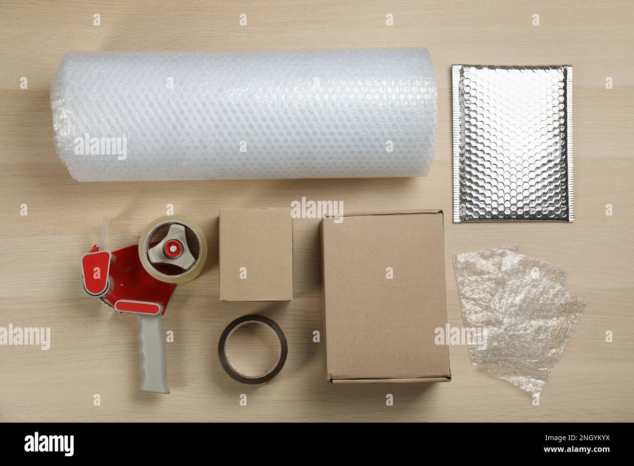 Flat lay composition with bubble wrap roll on wooden background Stock ...