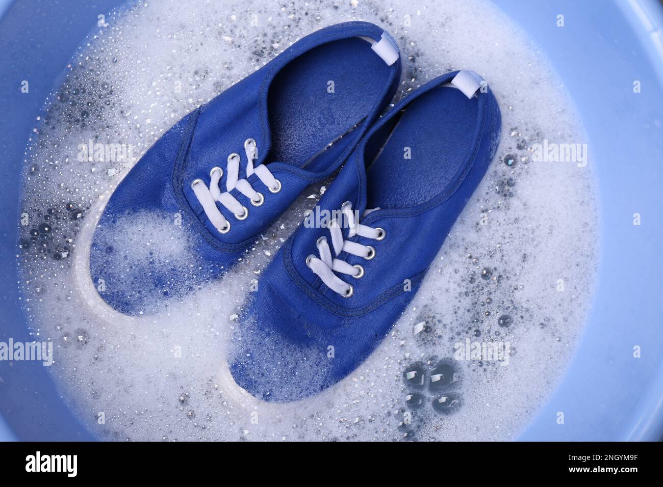Washing sport shoes in plastic basin, top view Stock Photo - Alamy