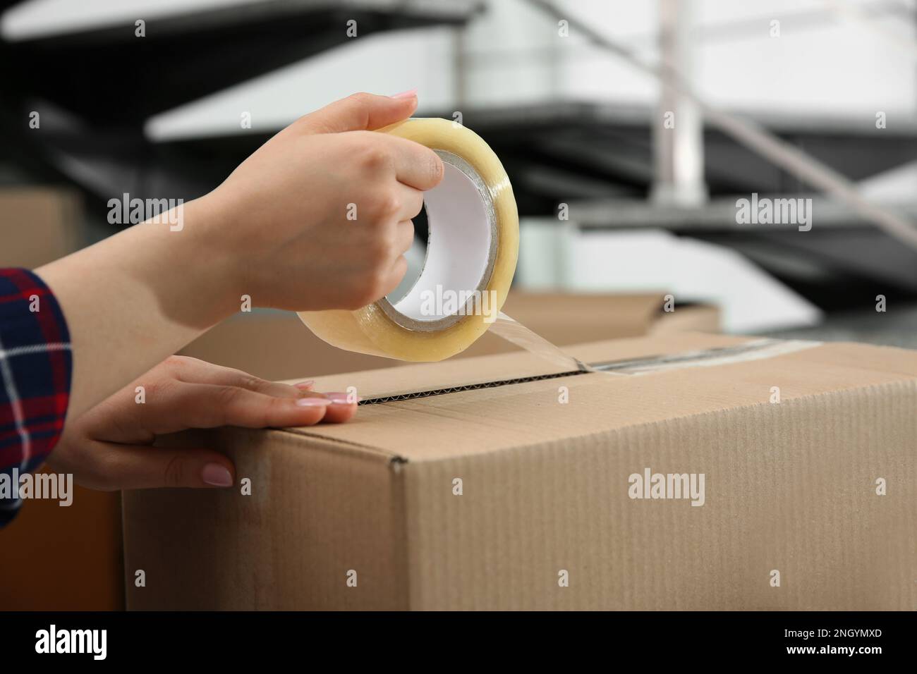 Female taping box warehouse hi-res stock photography and images - Alamy