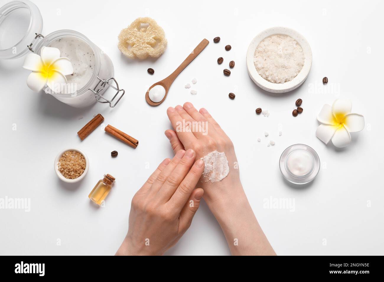 Woman applying body scrub on hand against white background, top view ...