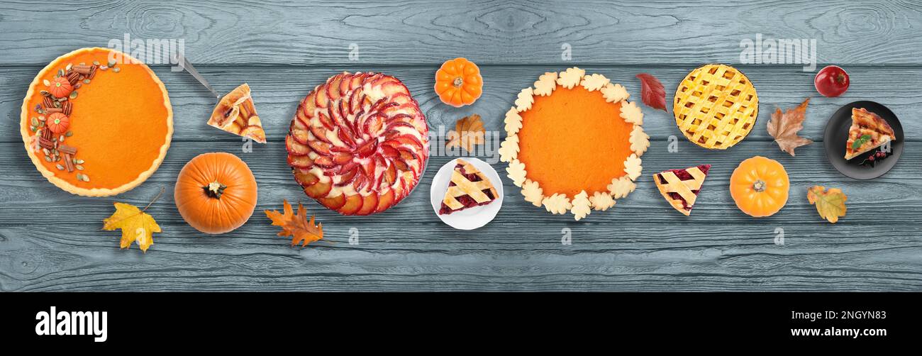 Flat lay composition with different tasty pies on wooden table. Banner ...